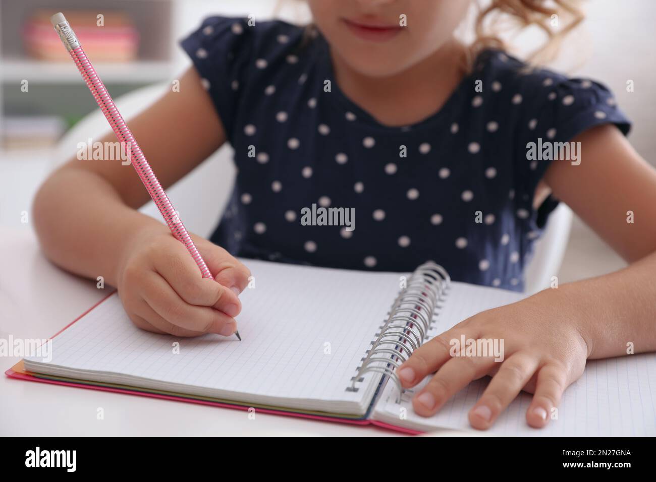 Little girl doing homework at table, closeup Stock Photo - Alamy