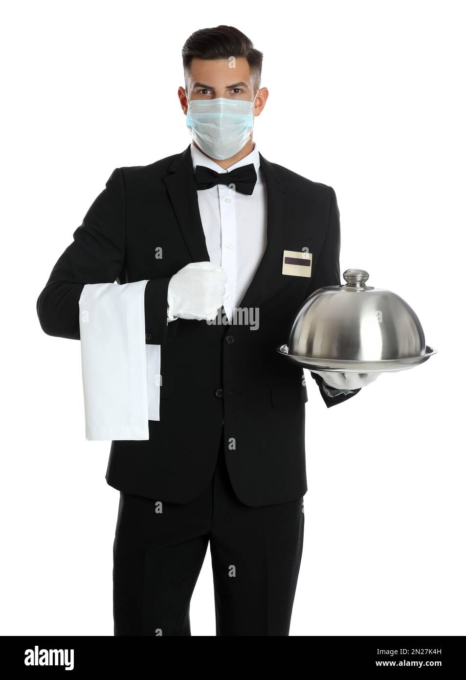 Waiter in medical face mask holding tray with lid on white background ...