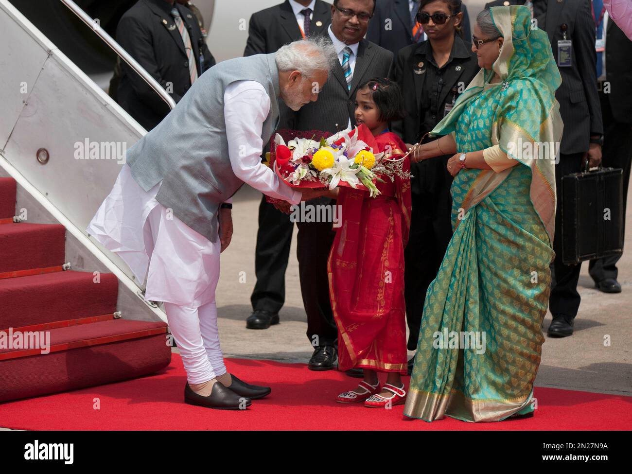 Indian Prime Minister Narendra Modi receives a bouquet of flowers upon ...