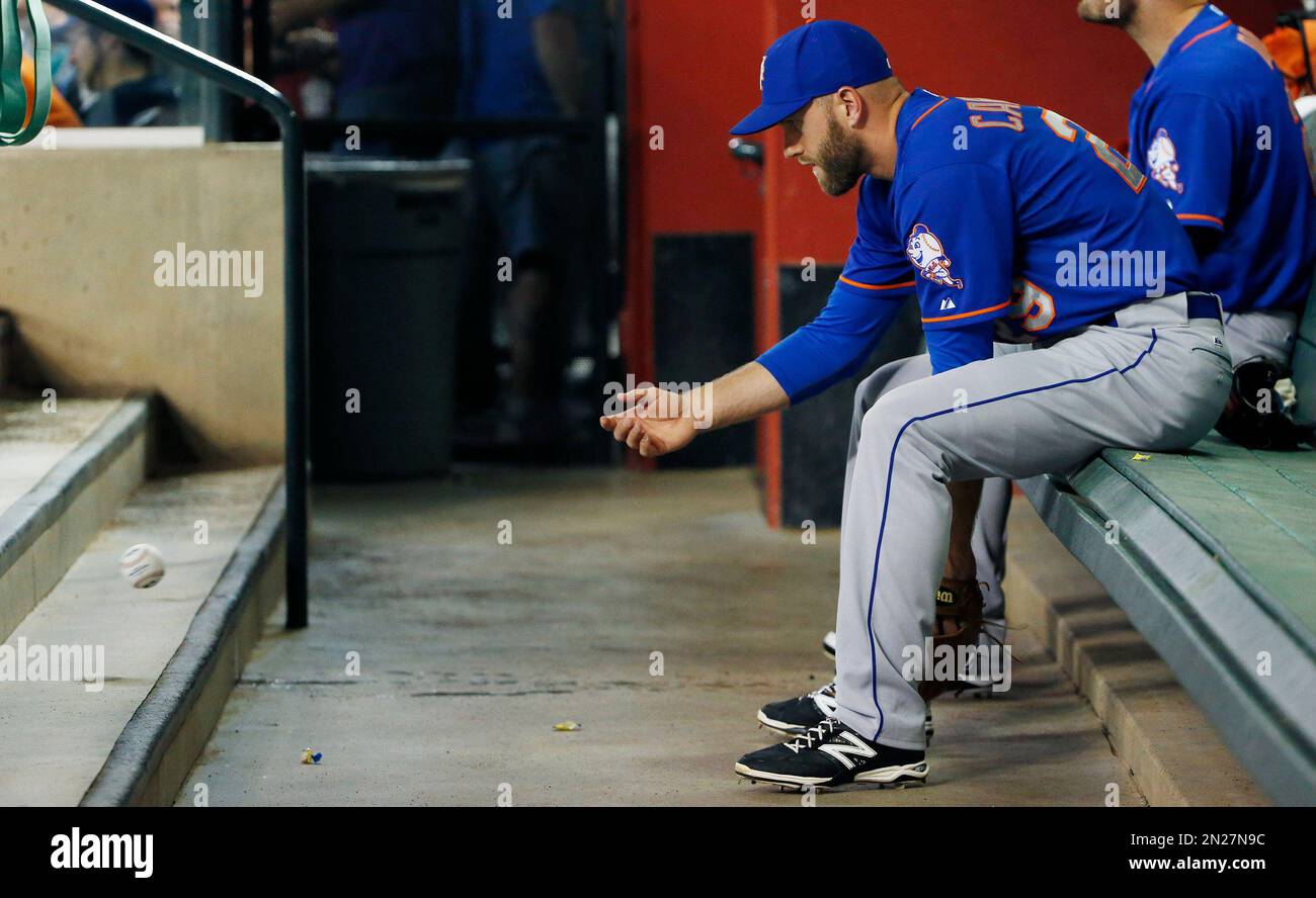 New York Mets' Eric Campbell tosses the baseball against the stairs in ...