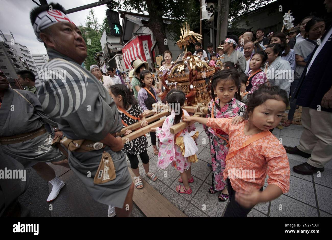 Children from a local neighborhood chant while carrying a portable ...