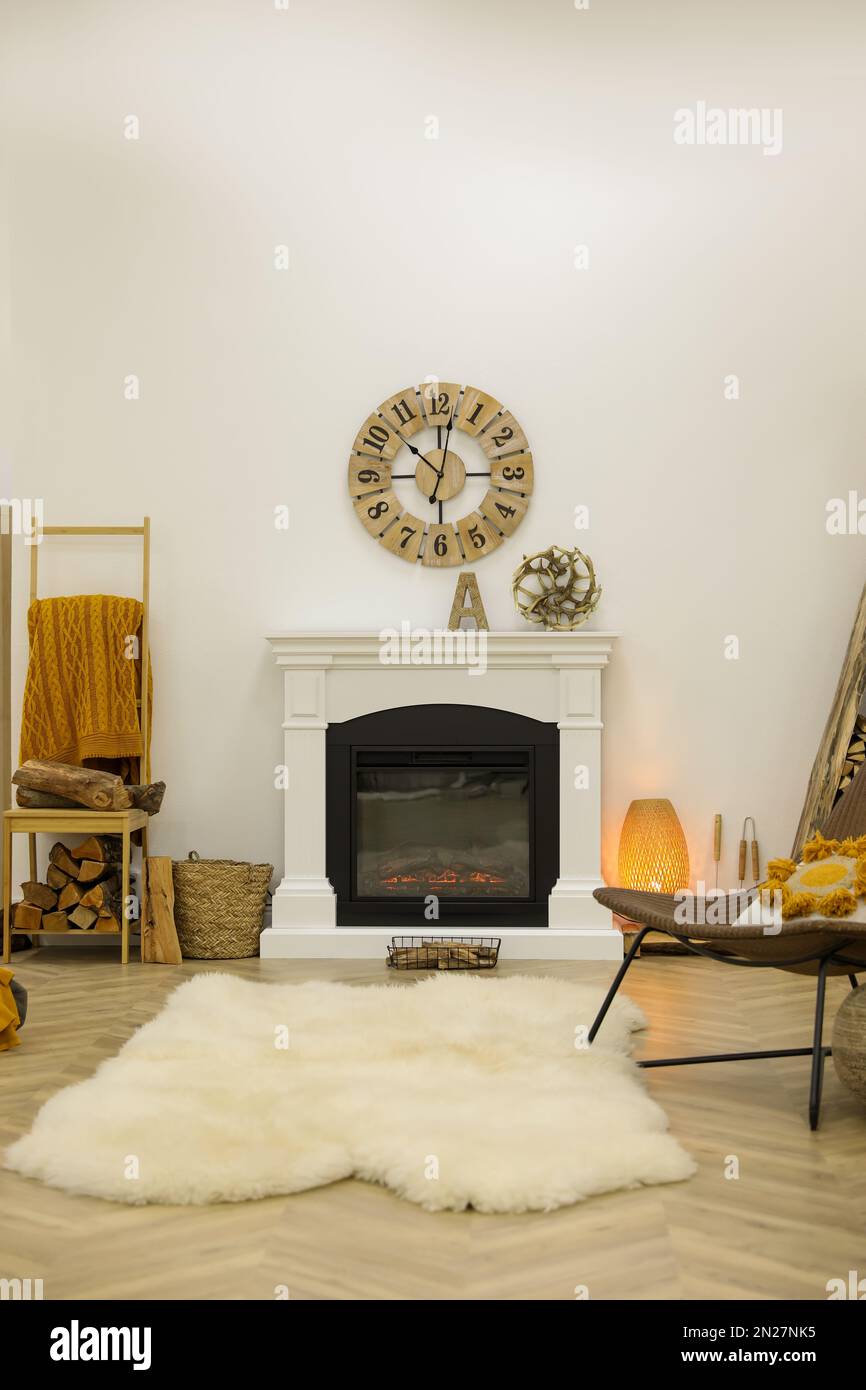 Elegant fireplace with burning flame in contemporary room interior ...