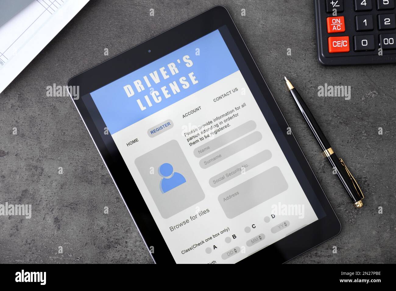 Tablet with driver's license application form, pen and calculator on grey table, flat lay Stock ...