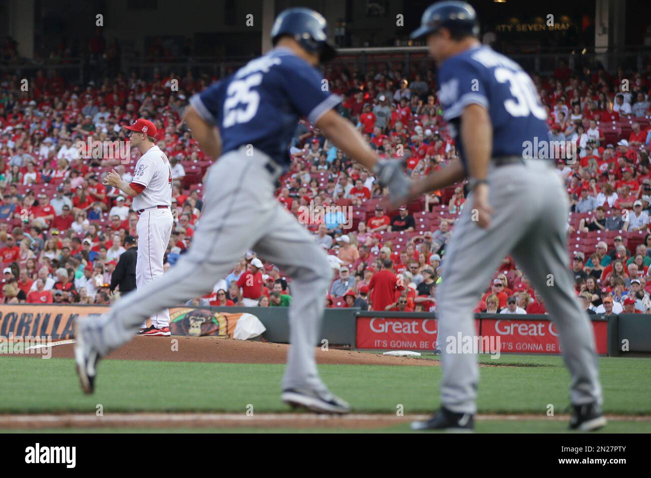 Cincinnati Reds starting pitcher Jon Moscot, back left, stands on the ...