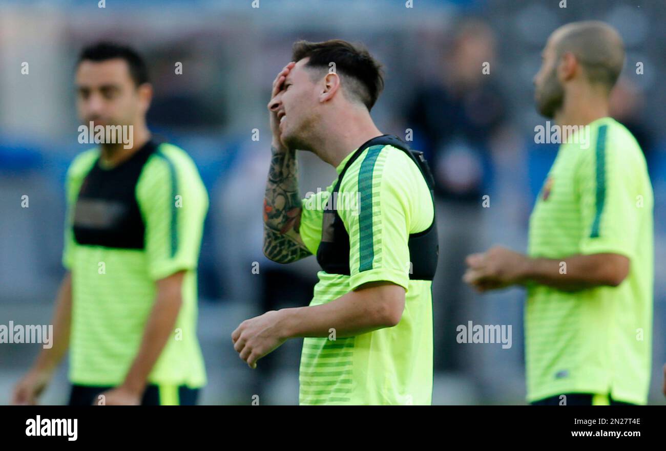 Barcelona's Lionel Messi touches his forehead during a training session ...