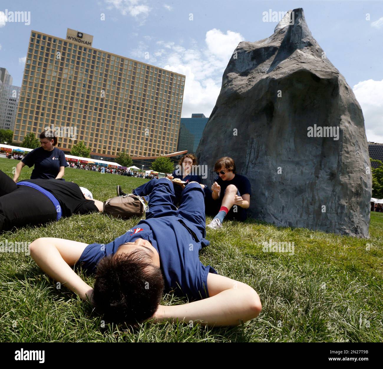 Ken Cheng, bottom, stretches out on the grass with classmates from the ...