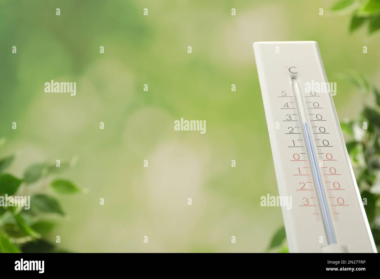Weather thermometer on blurred background, closeup. Space for text ...