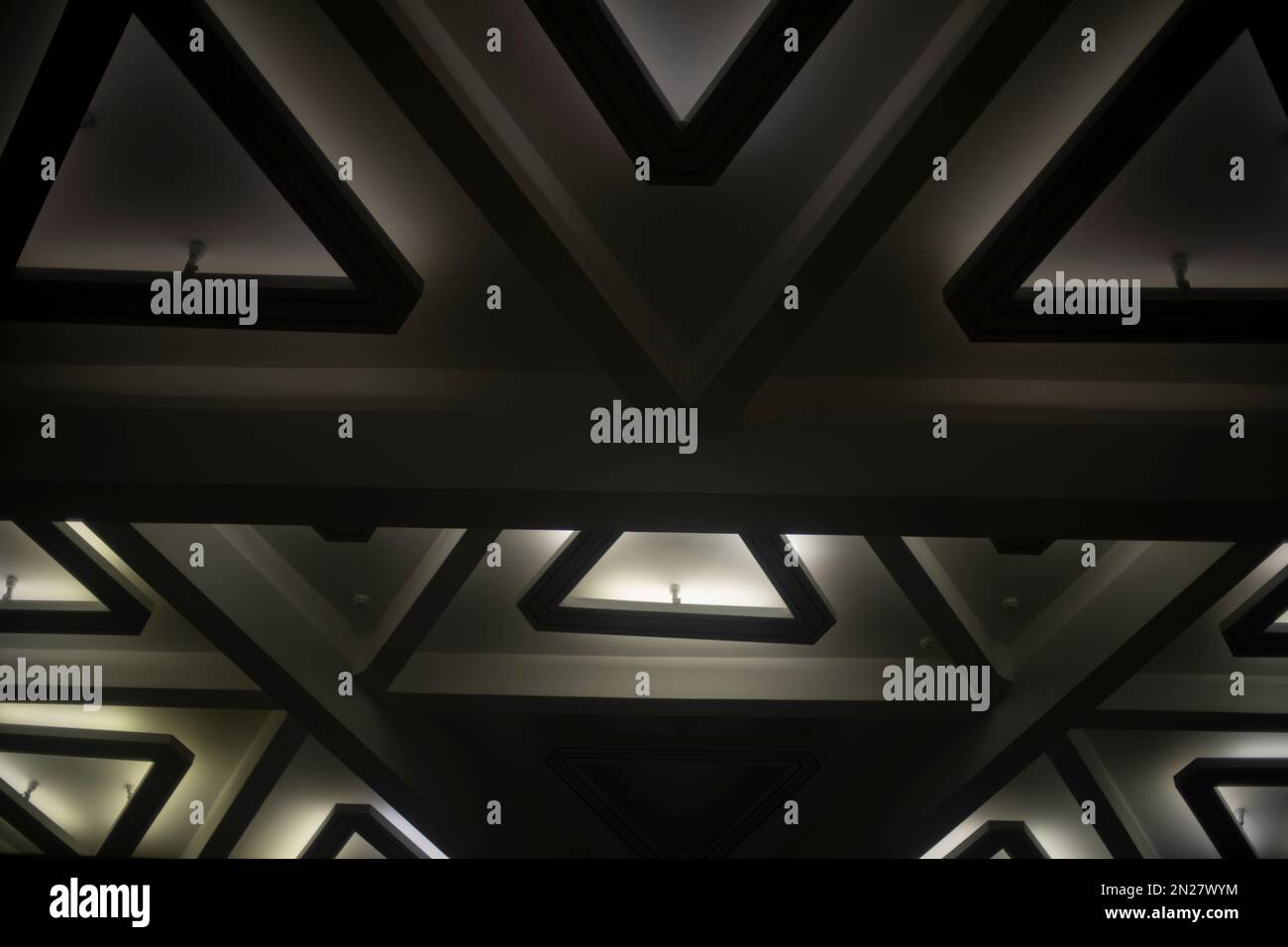 Light of lamps on ceiling. Architecture details. Triangles in building ...