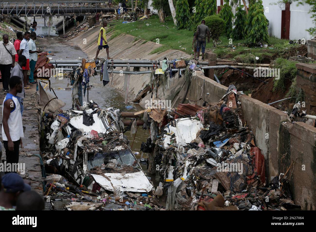 People gather around cars destroyed by flash floods in Accra, Ghana ...