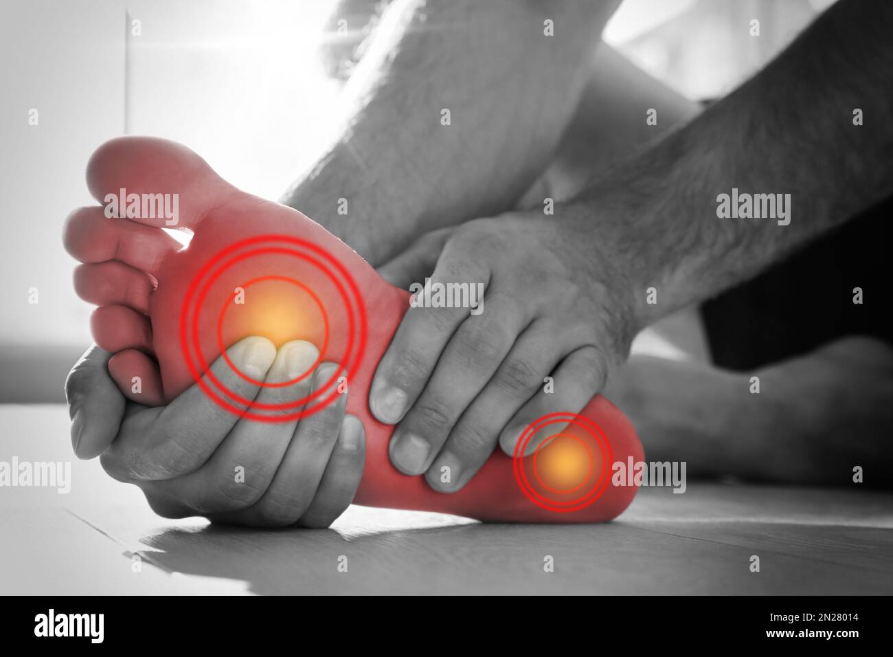 Man suffering from foot pain at home, closeup Stock Photo - Alamy