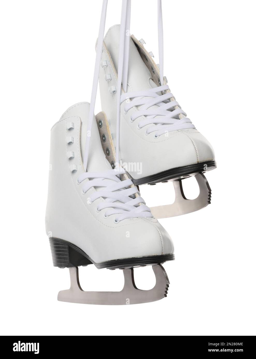 Pair of figure ice skates hanging on white background Stock Photo - Alamy