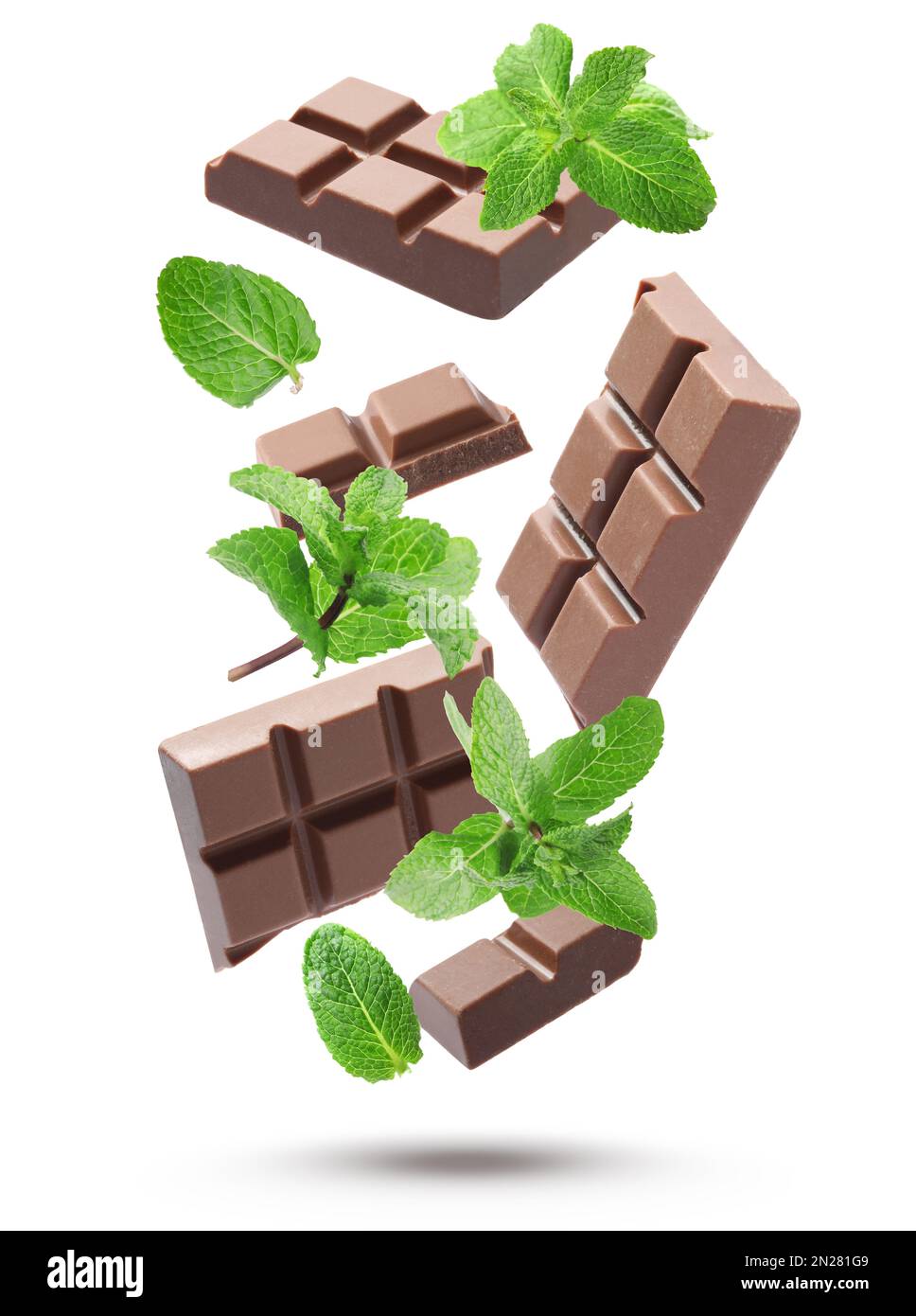 Milk chocolate pieces and mint falling on white background Stock Photo ...