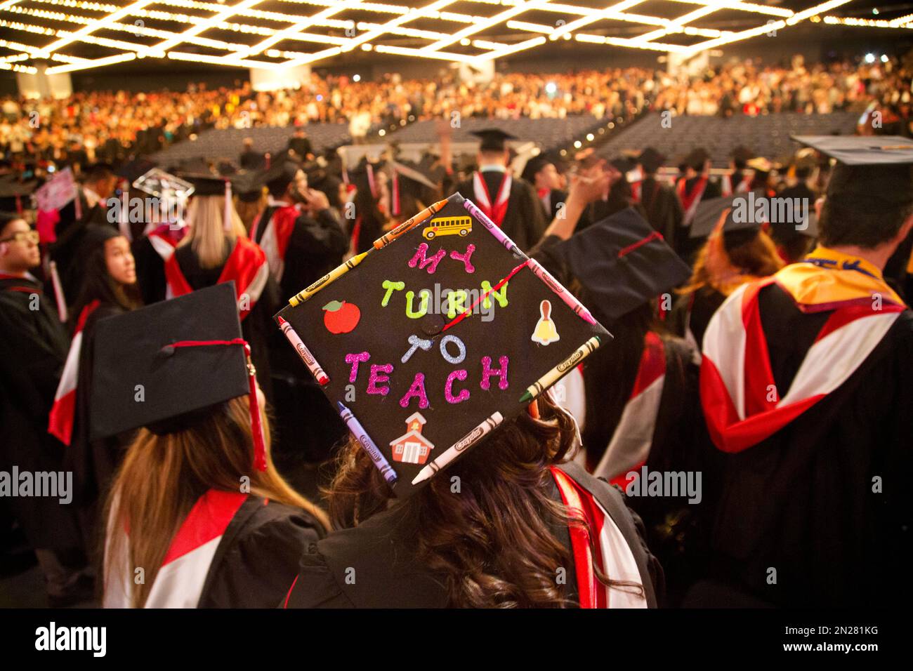 A graduate of LaGuardia Community College wears a mortar board with the ...