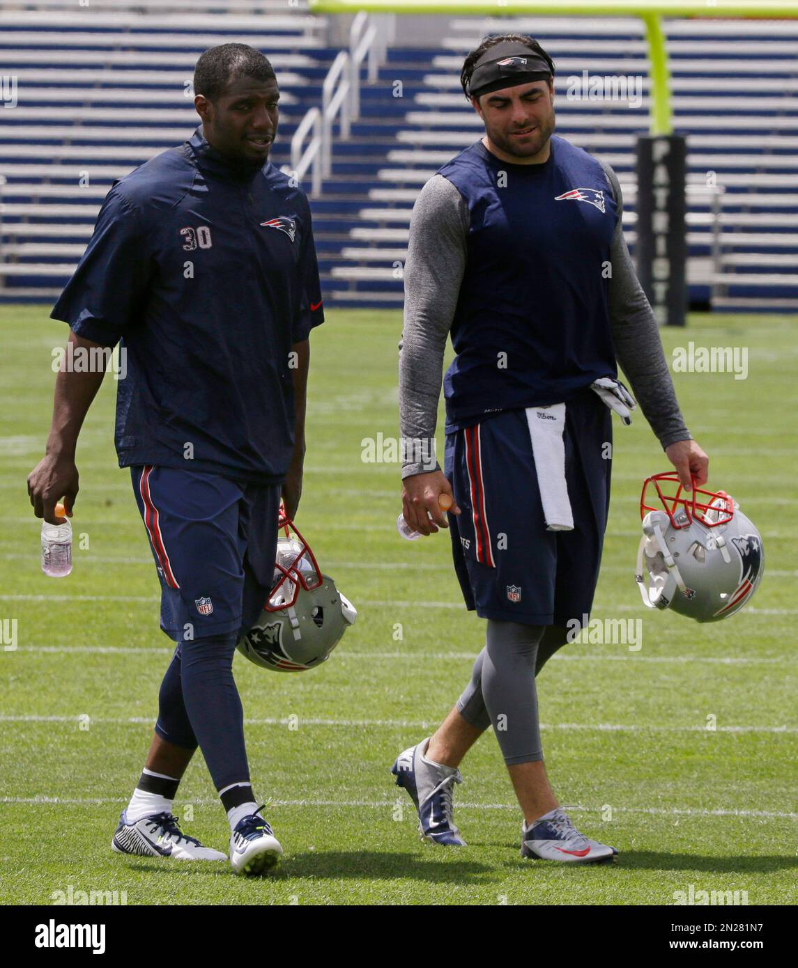 New England Patriots strong safety Duron Harmon, left, and defensive back Nate Ebner (43) walk ...