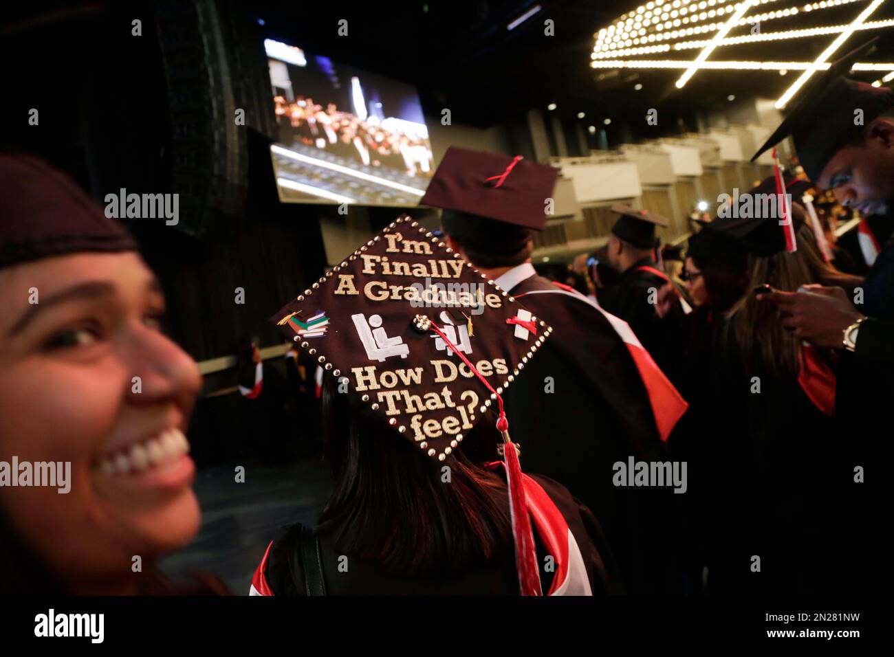 A graduate of LaGuardia Community College wears a mortarboard with the ...