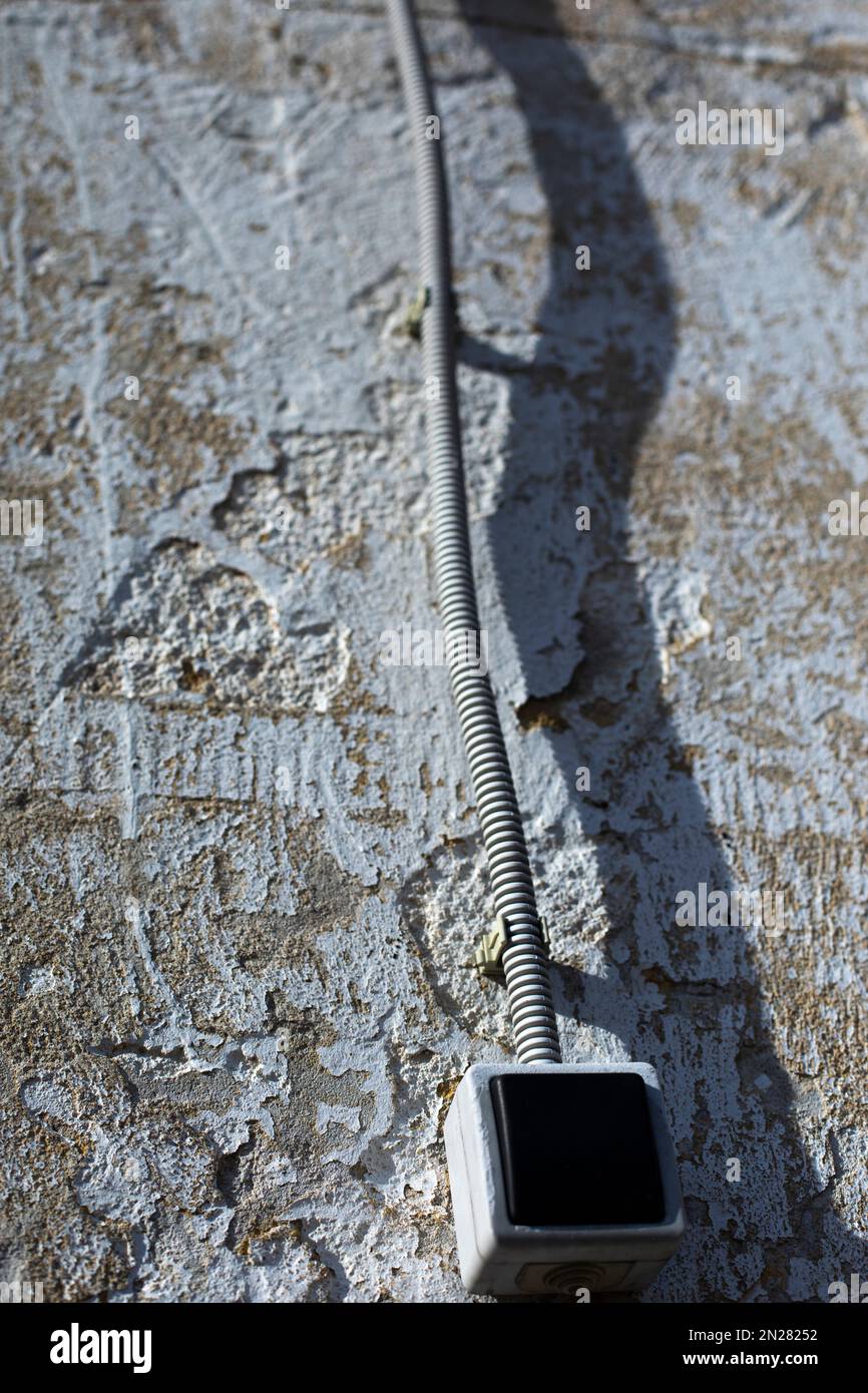Wire on wall. Electrical wiring in building. Current insulation ...