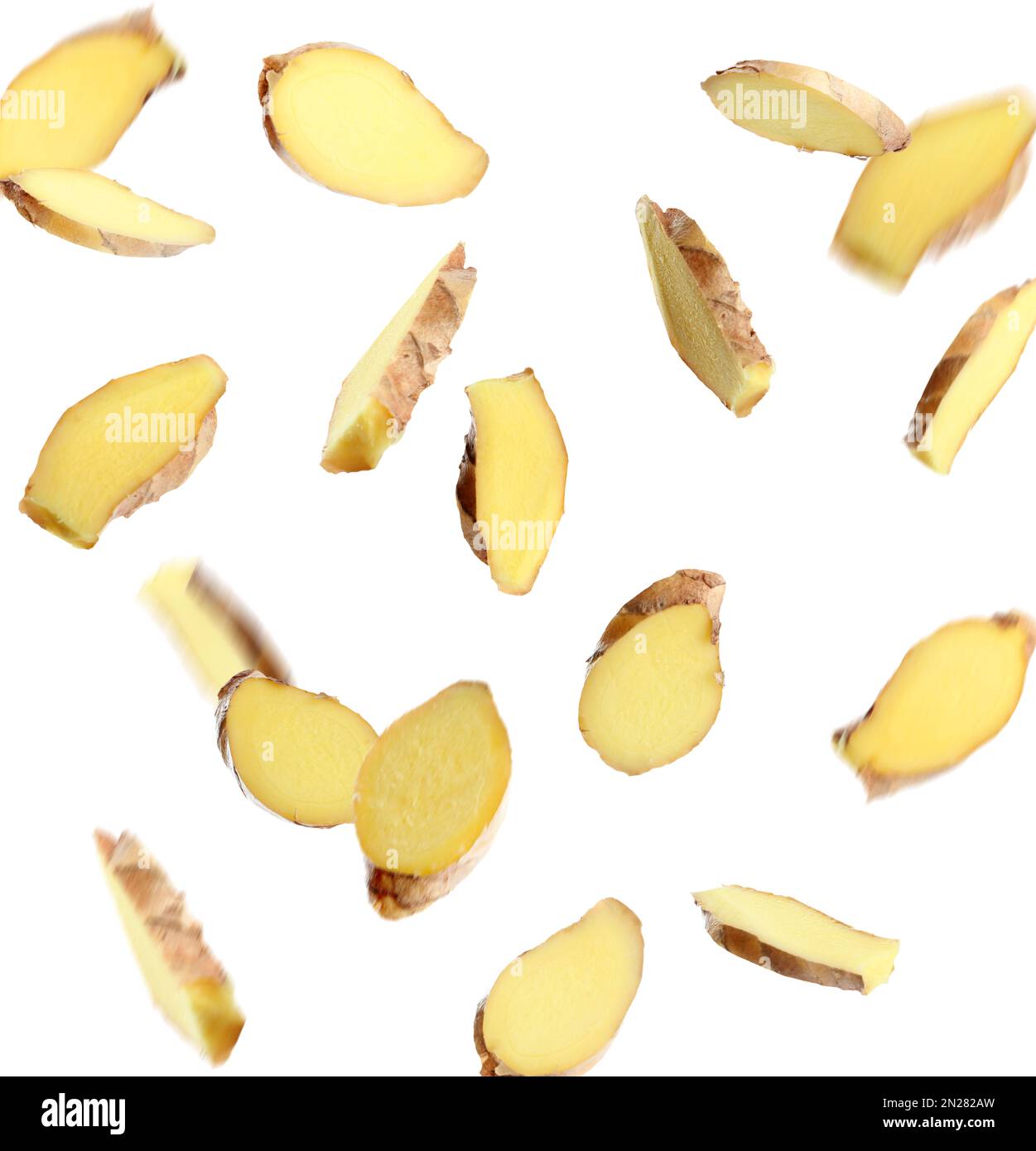 Fresh sliced ginger falling on white background Stock Photo - Alamy