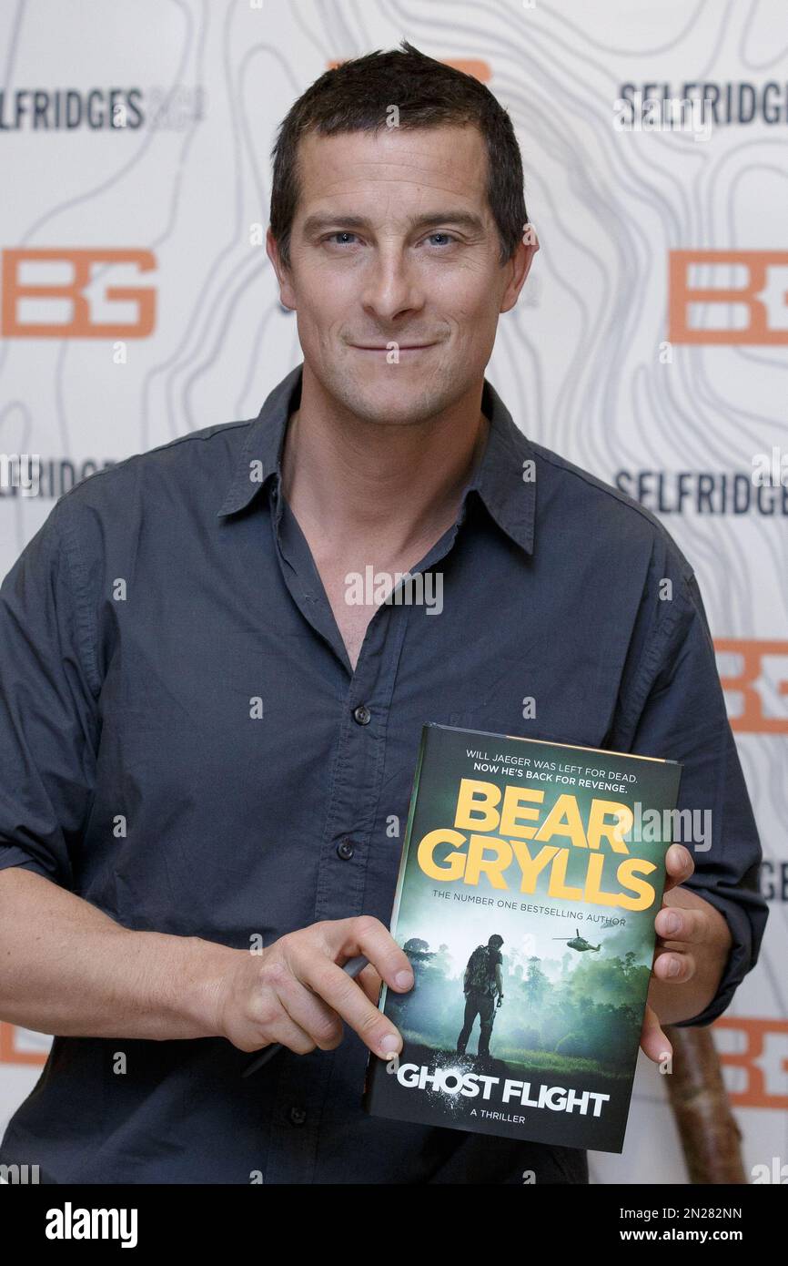 Adventurer Bear Grylls poses for photographers before signing copies of his new book at a ...