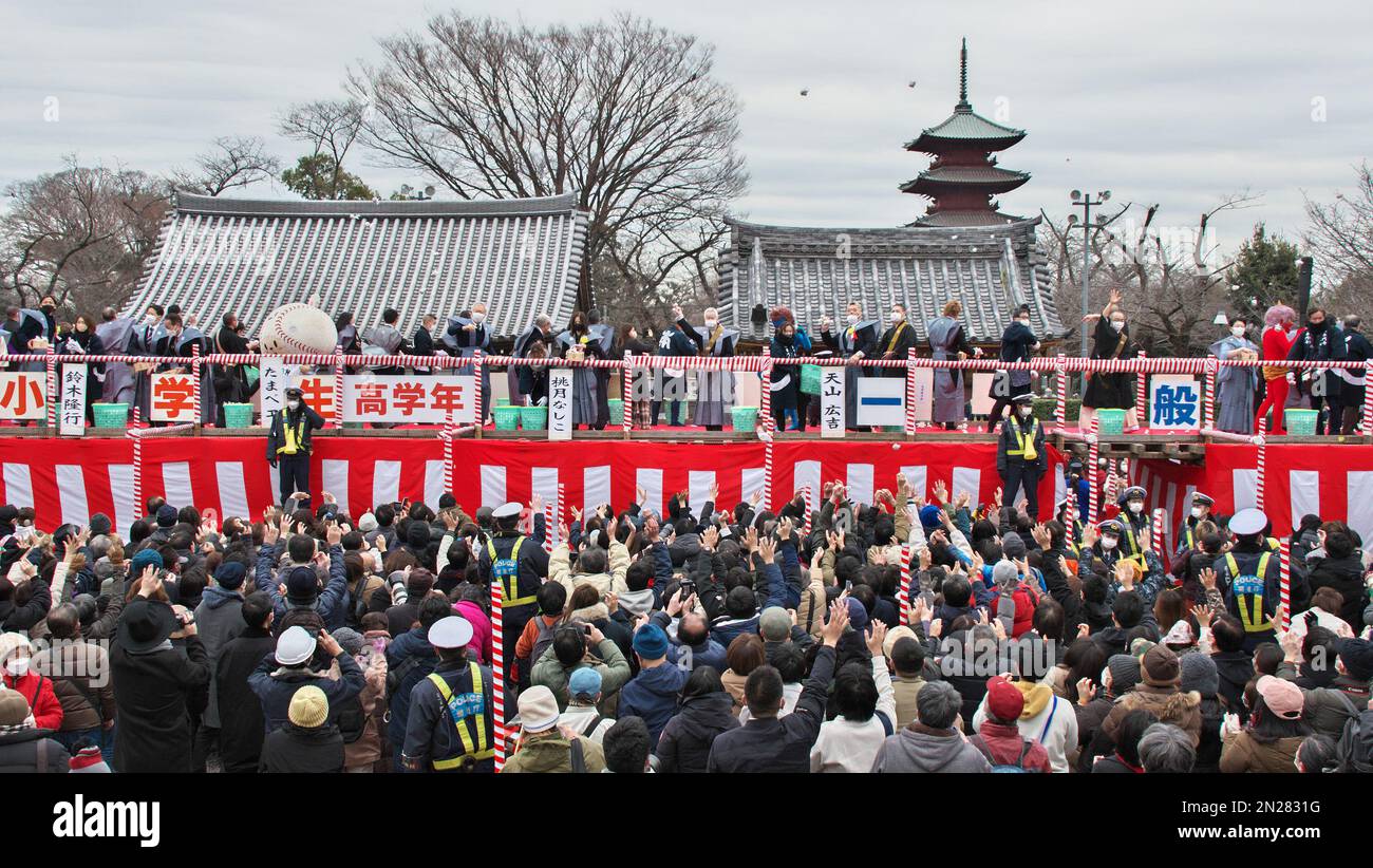 Local celebrities throw beans during the bean-throwing ceremony at ...