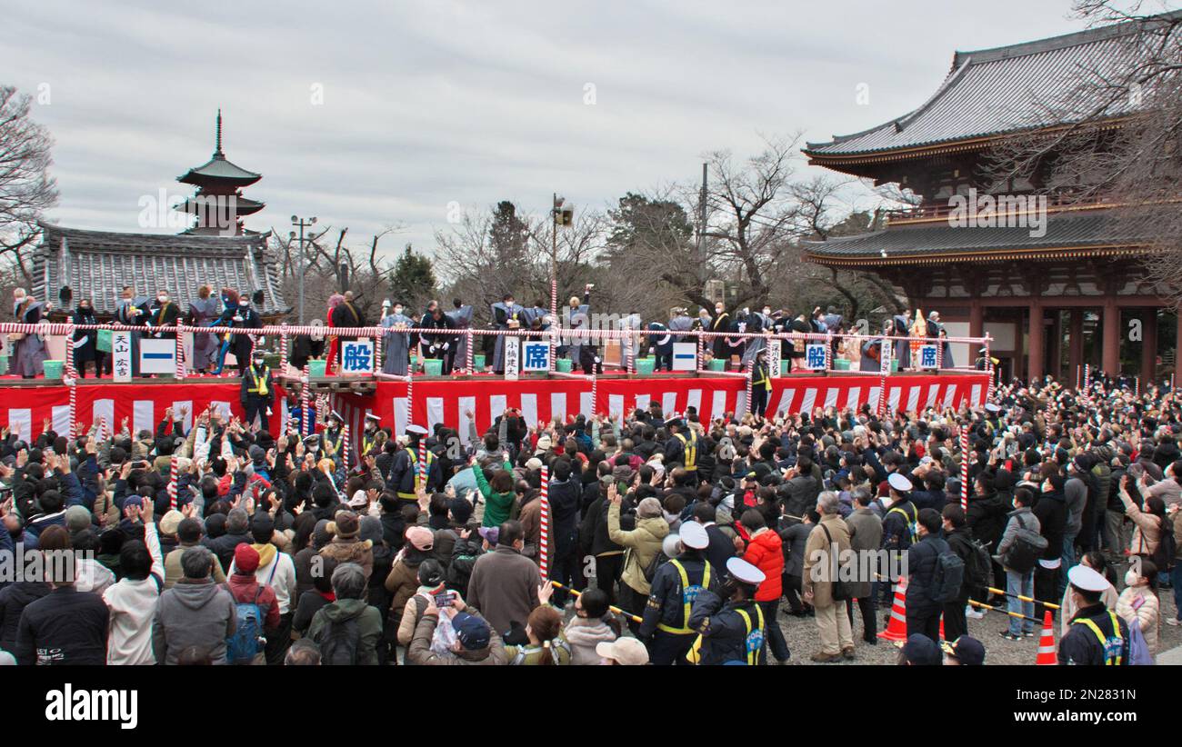 Local celebrities throw beans during the bean-throwing ceremony at ...