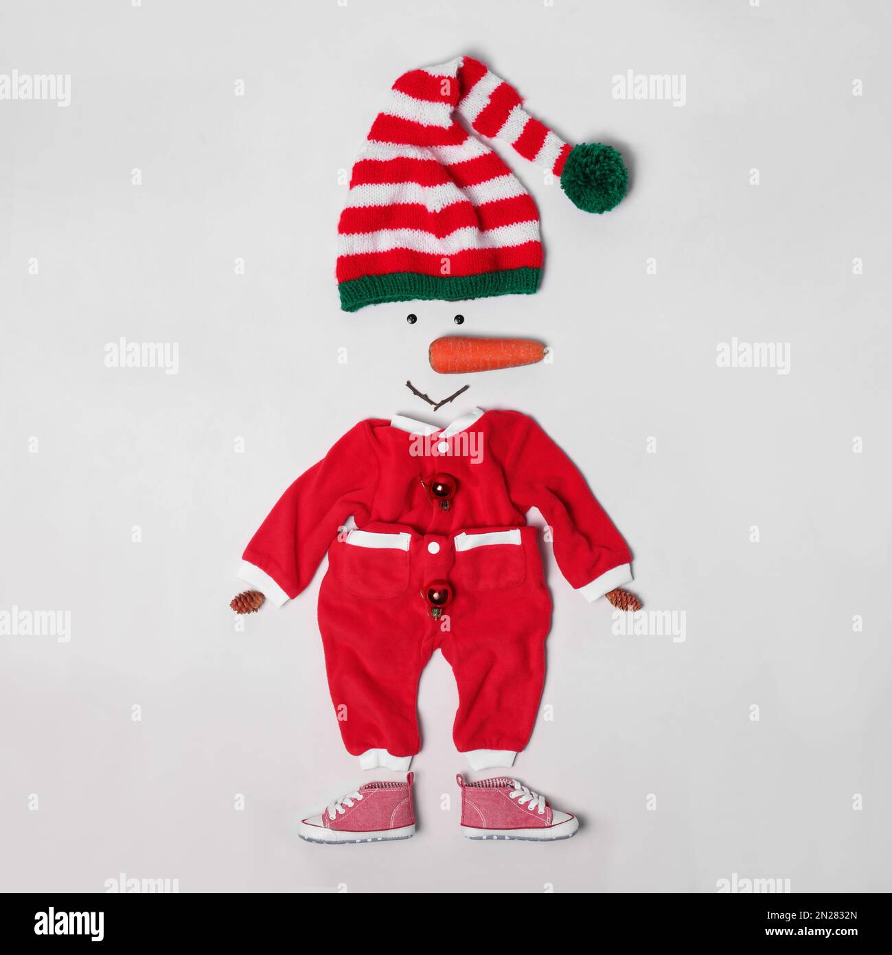 Creative snowman shape made of Santa elf's hat, red suit and different ...
