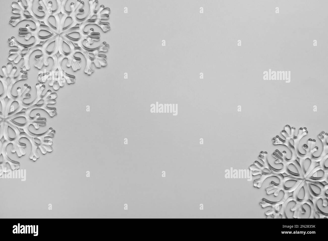 Beautiful decorative snowflakes on light grey background, flat lay ...