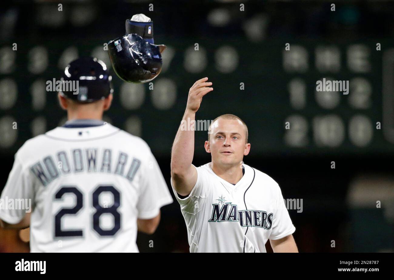 Seattle Mariners' Kyle Seager tosses his batting helmet to first base ...