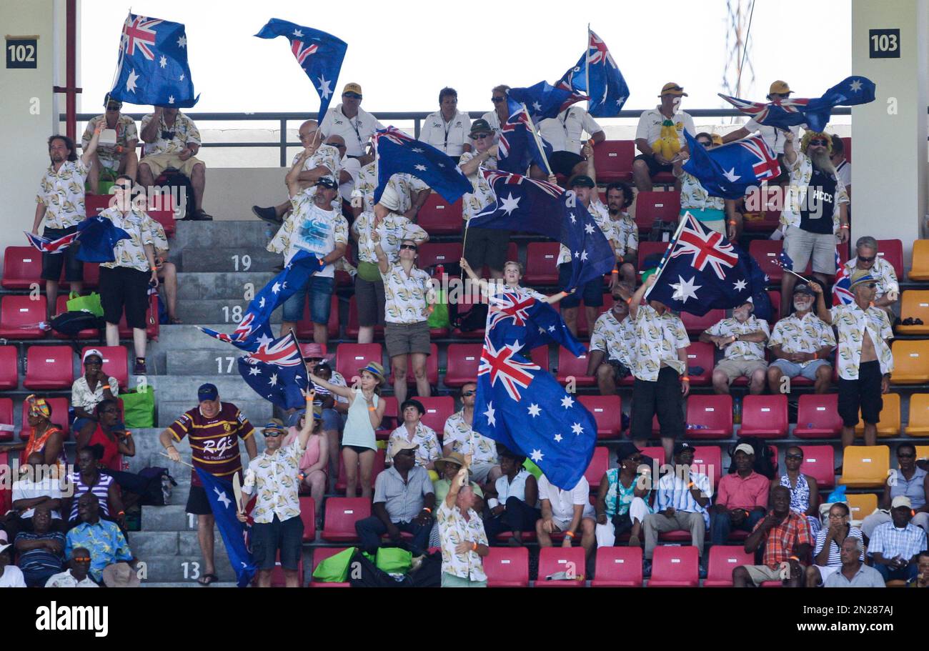 Cricket fans wave Australian national flags during the opening day of ...