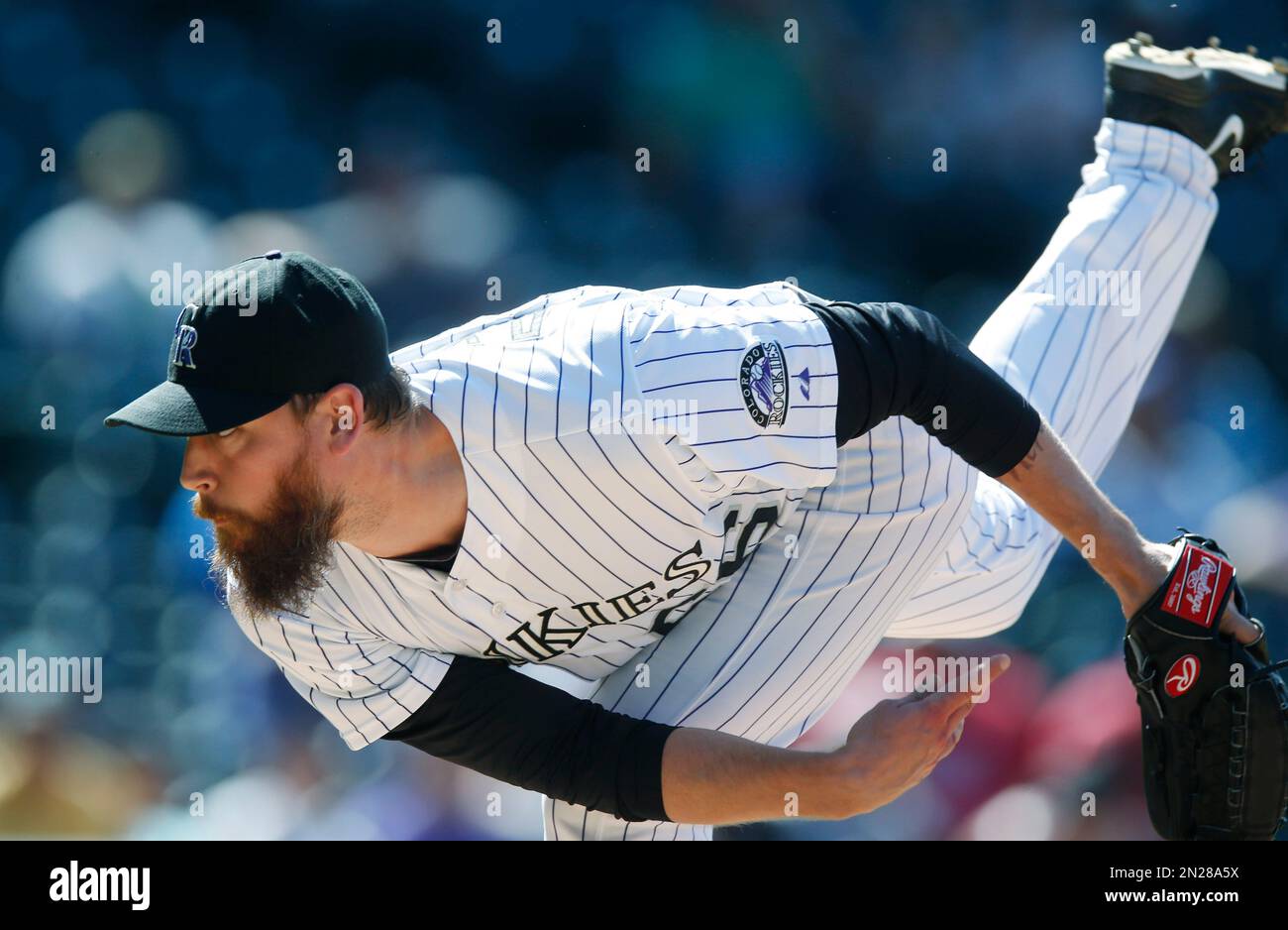Colorado Rockies relief pitcher John Axford works against the Los ...
