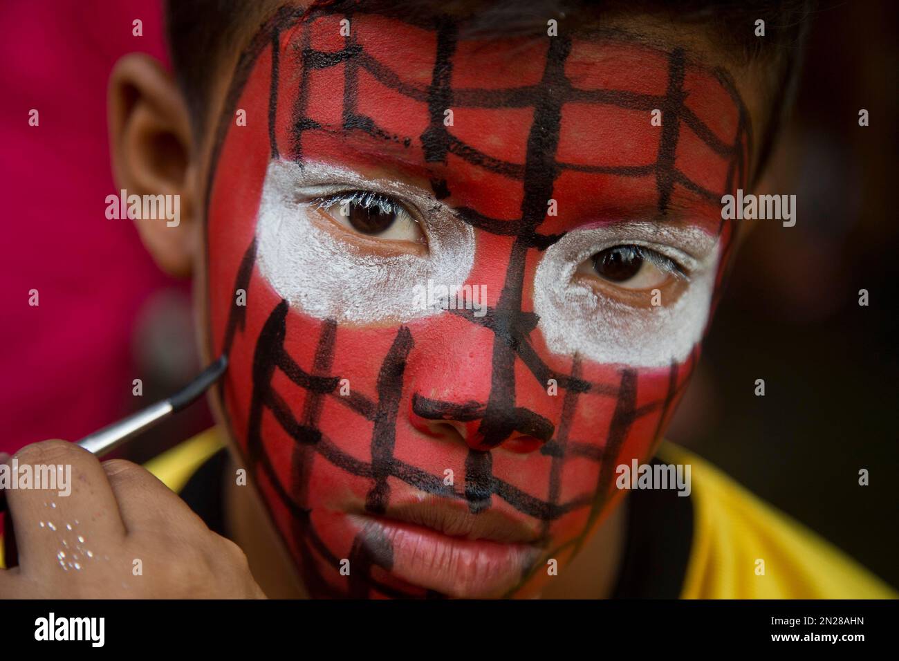 A boy has his face painted during the celebration of Children's Day in ...