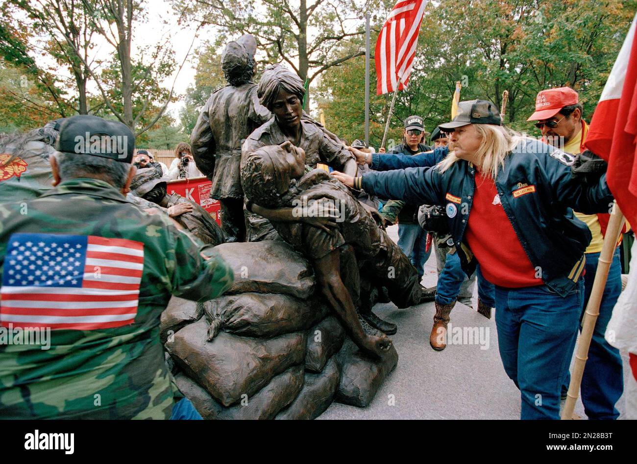 Veterans reach out to touch the Vietnam Women's Memorial in Washington ...