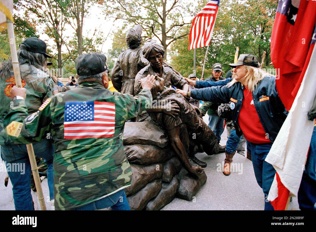 Vietnam veterans touch the Vietnam Women's Memorial after it was put in ...