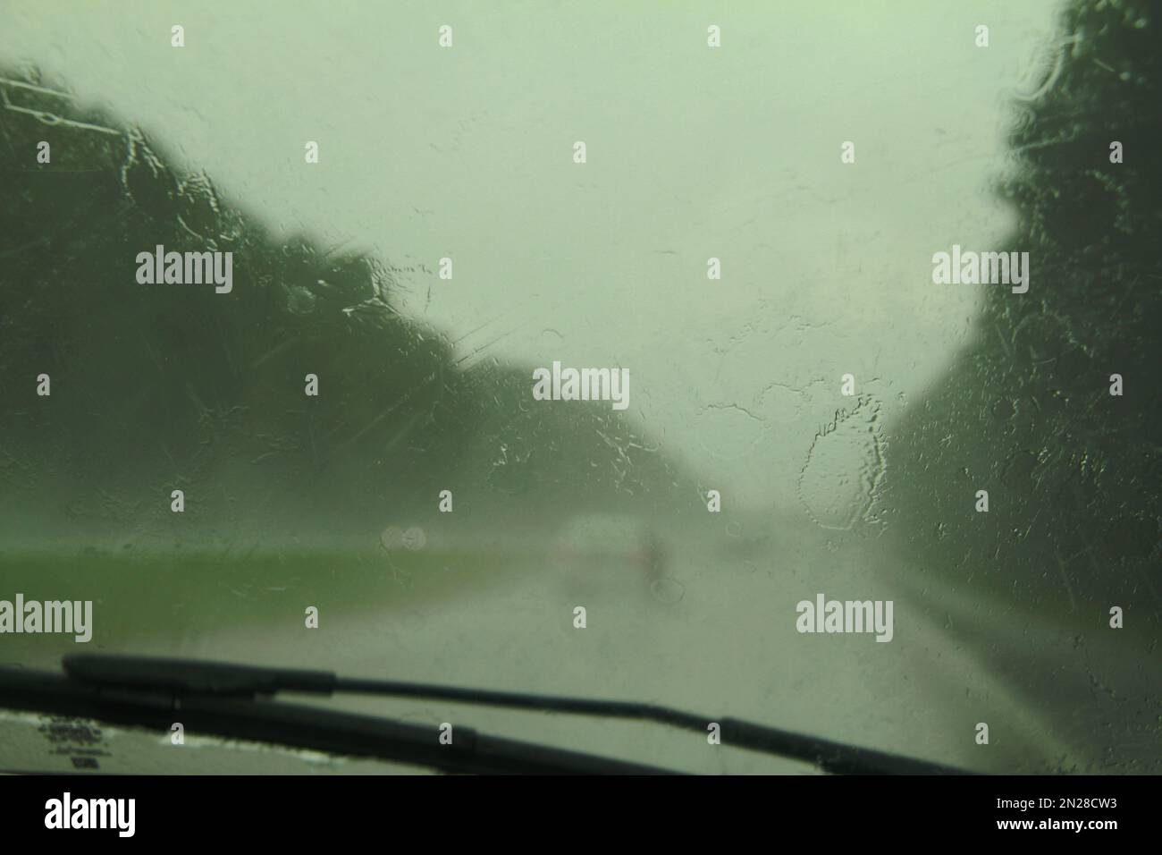 Rain water on the windshield. Low visibility during storm Stock Photo ...