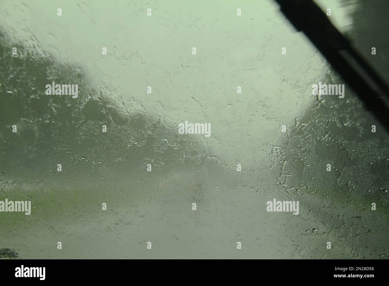 Rain water on the windshield. Low visibility during storm Stock Photo ...