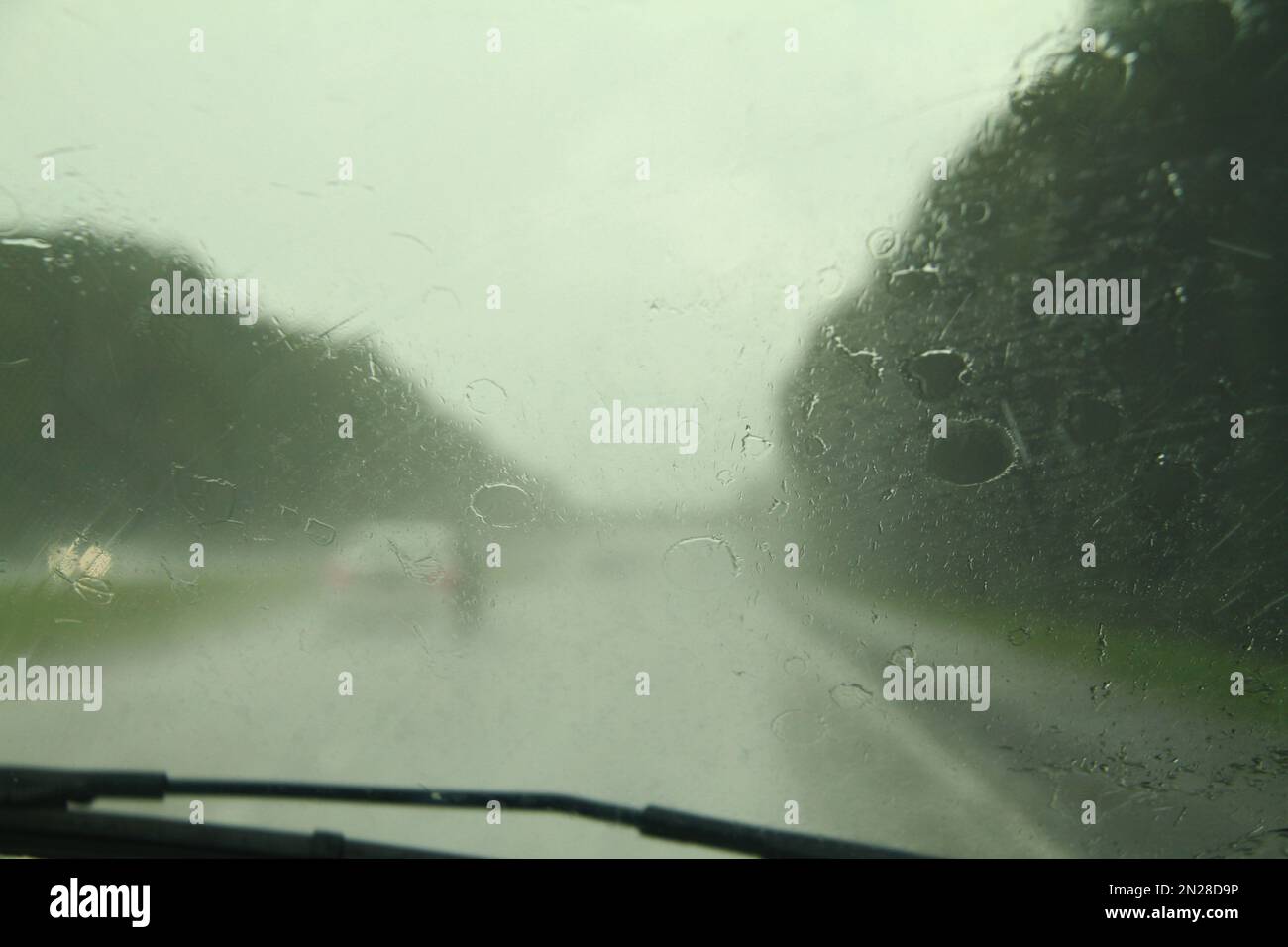 Rain water on the windshield. Low visibility during storm Stock Photo ...