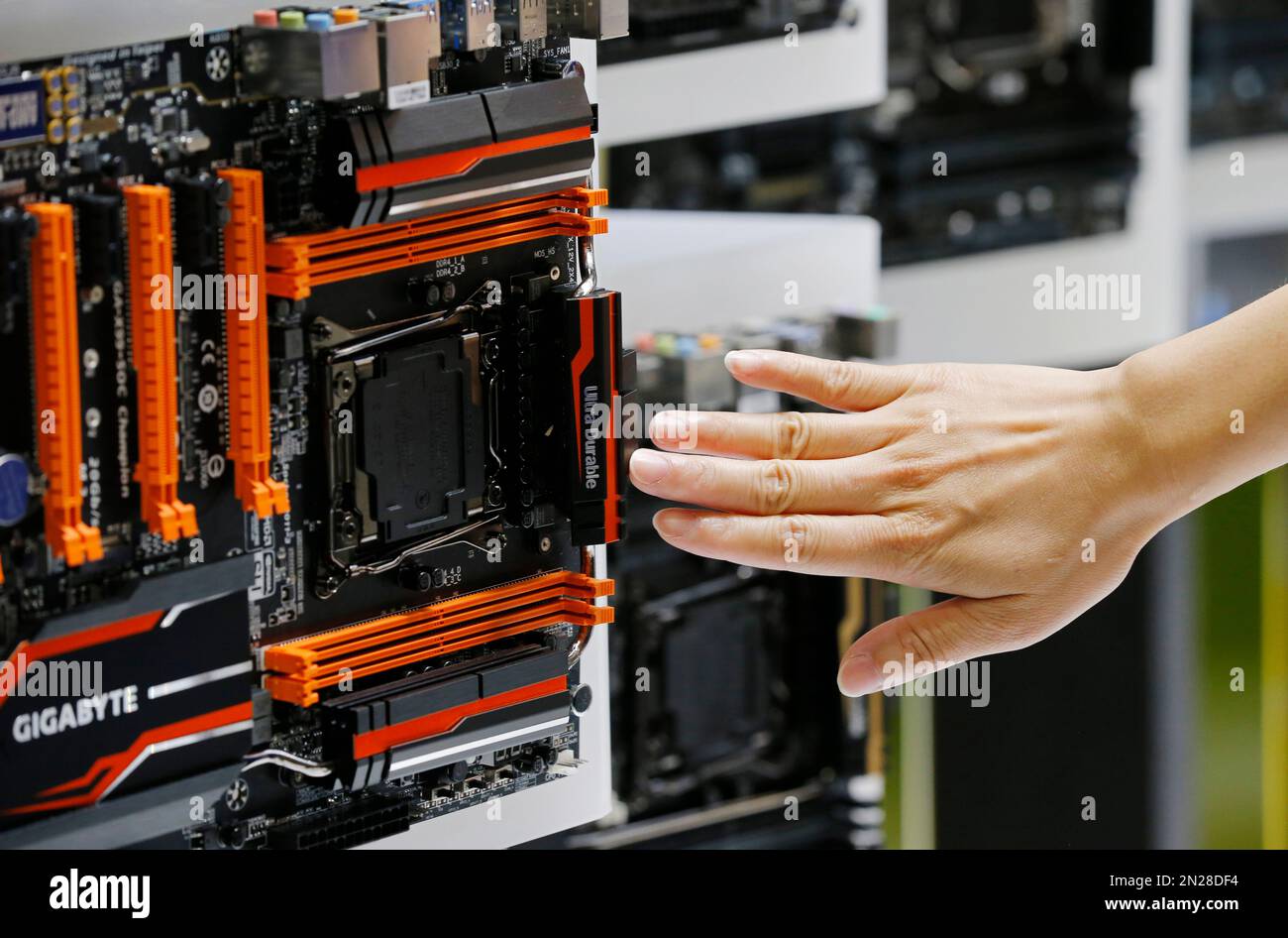 A visitor reviews Gigabyte motherboards on display at the Computex ...