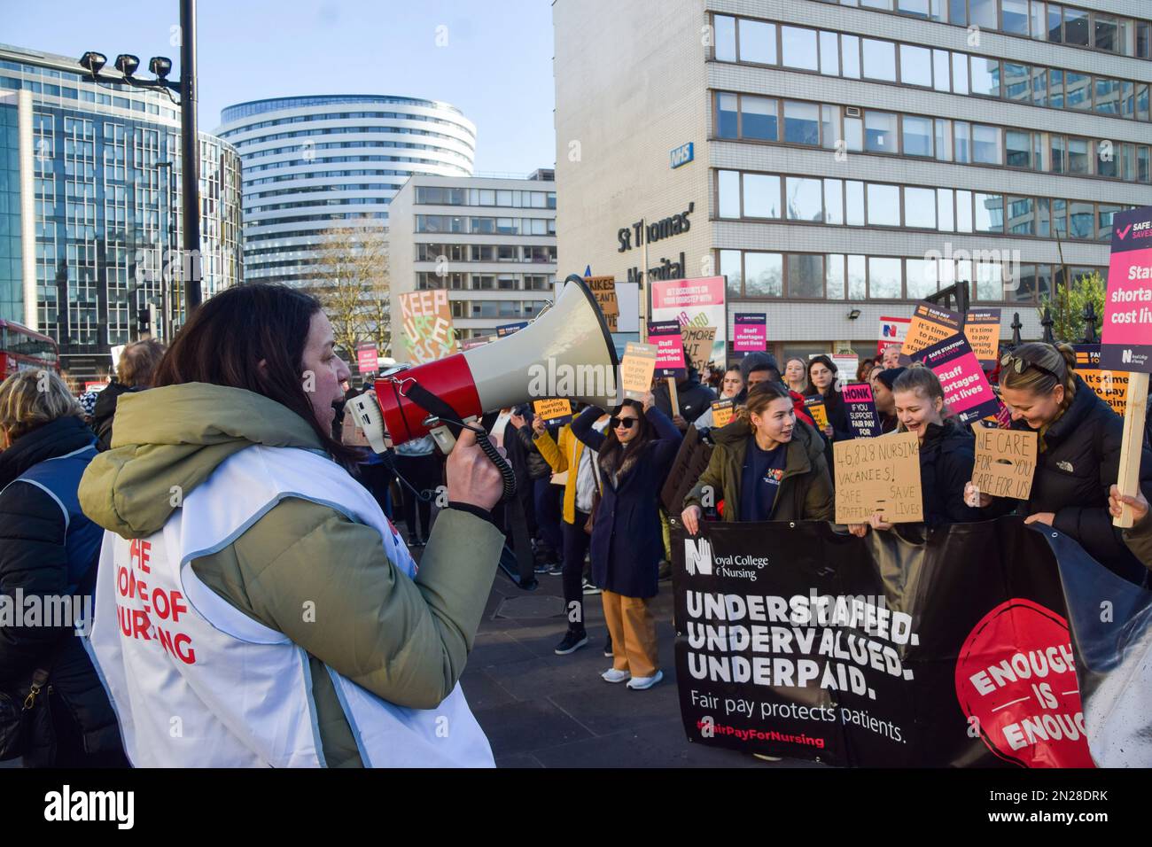 London, UK. 06th Feb, 2023. A nurse chants slogans through a megaphone ...