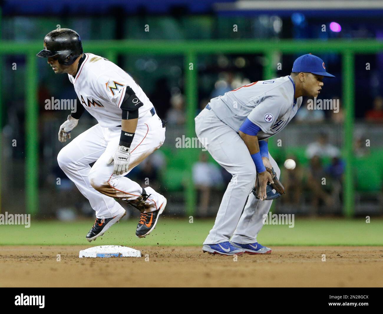 Miami Marlins' Martin Prado, left, reaches second base for a double as ...