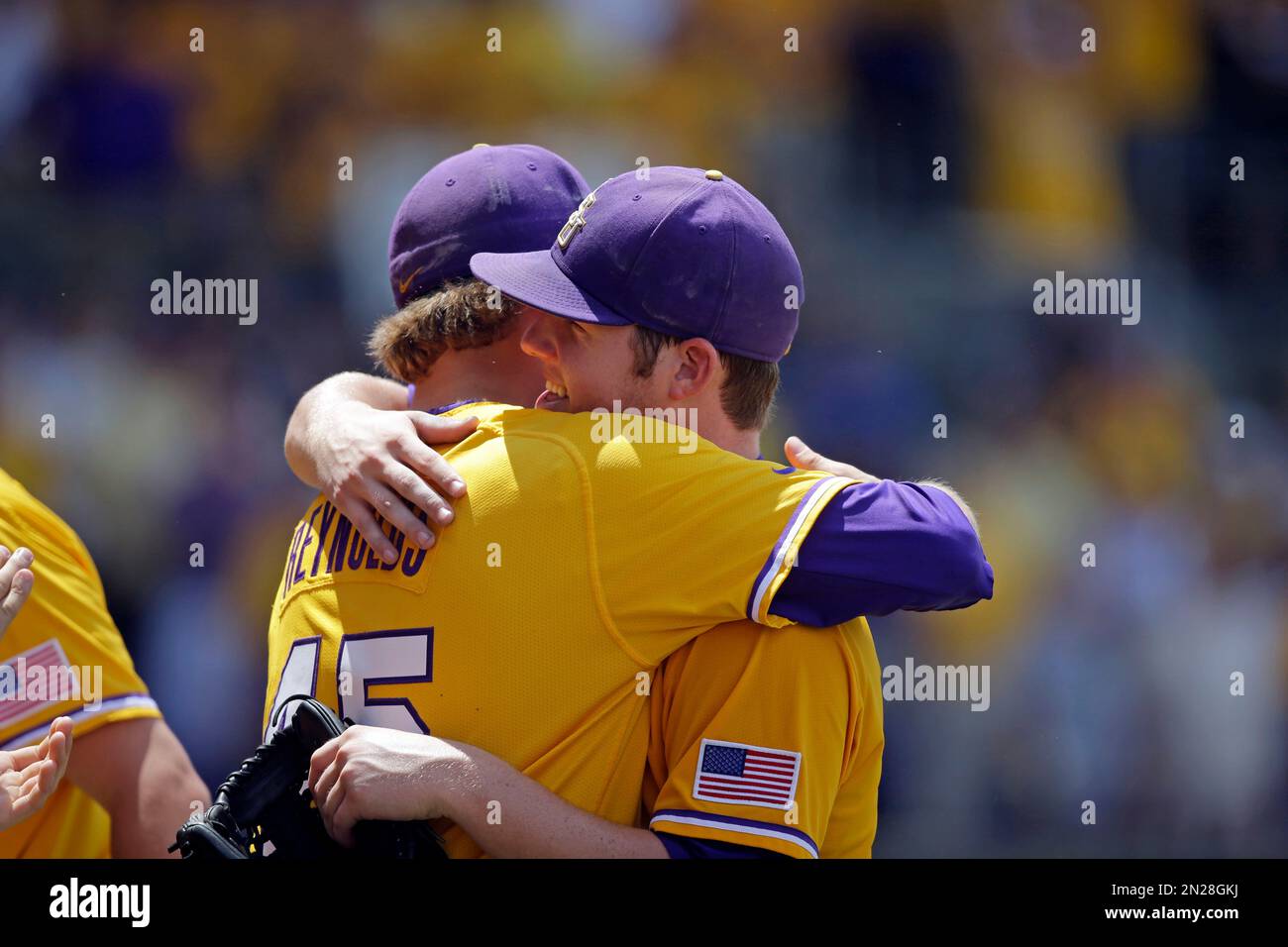 LSU pitcher Jared Poche' hugs pitcher Russell Reynolds (45) after Poche ...
