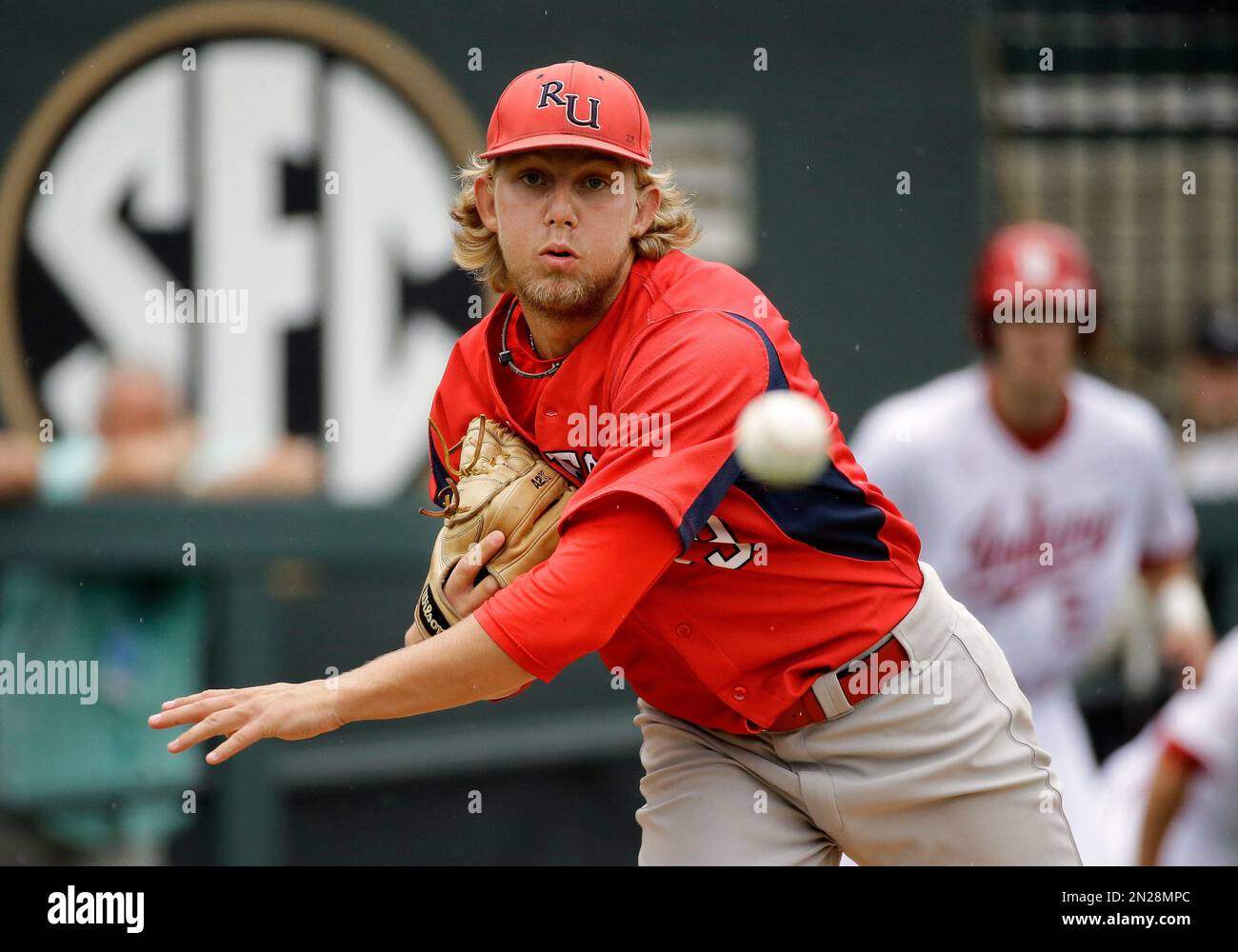 Radford pitcher Kyle Palmer makes a wild pickoff-attempt to first base ...