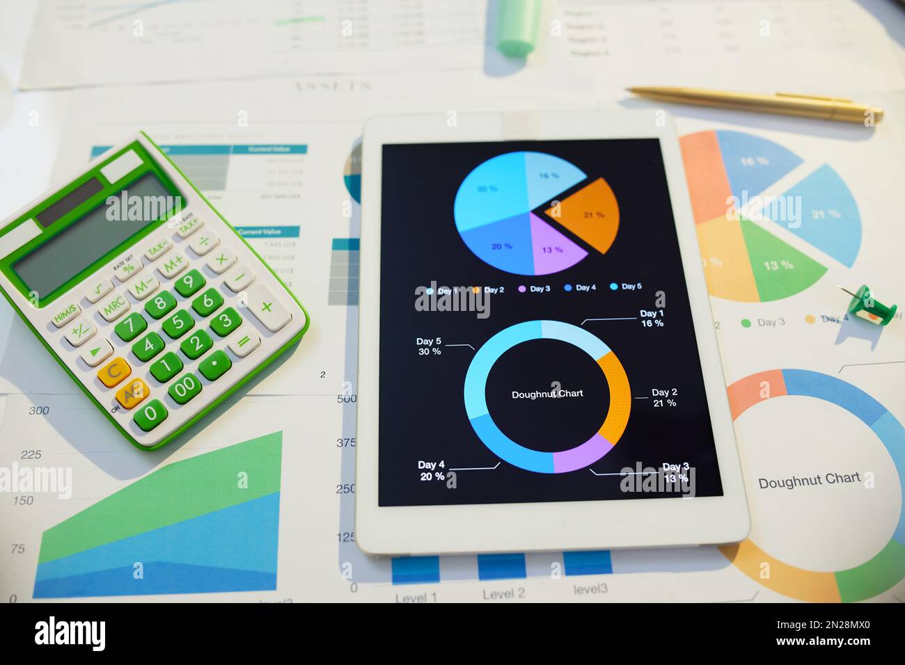 tablet pc, calculator, documents and graphs at desk Stock Photo - Alamy