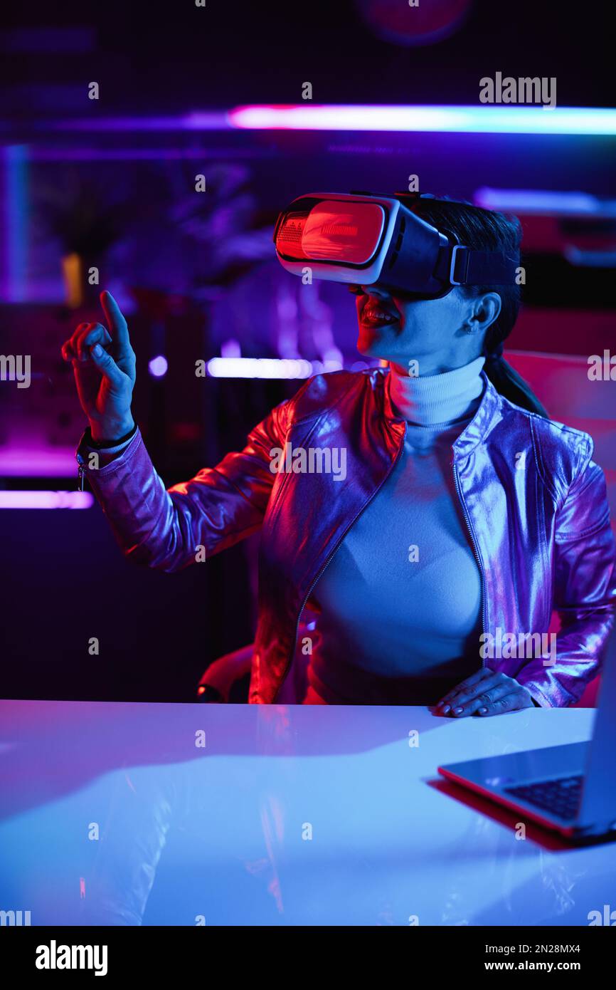 Neon metaverse futuristic concept. smiling modern 40 years old woman in ...