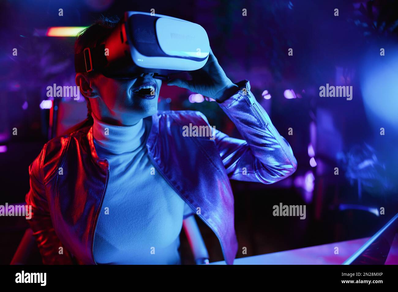 Neon metaverse futuristic concept. smiling trendy female in vr headset ...