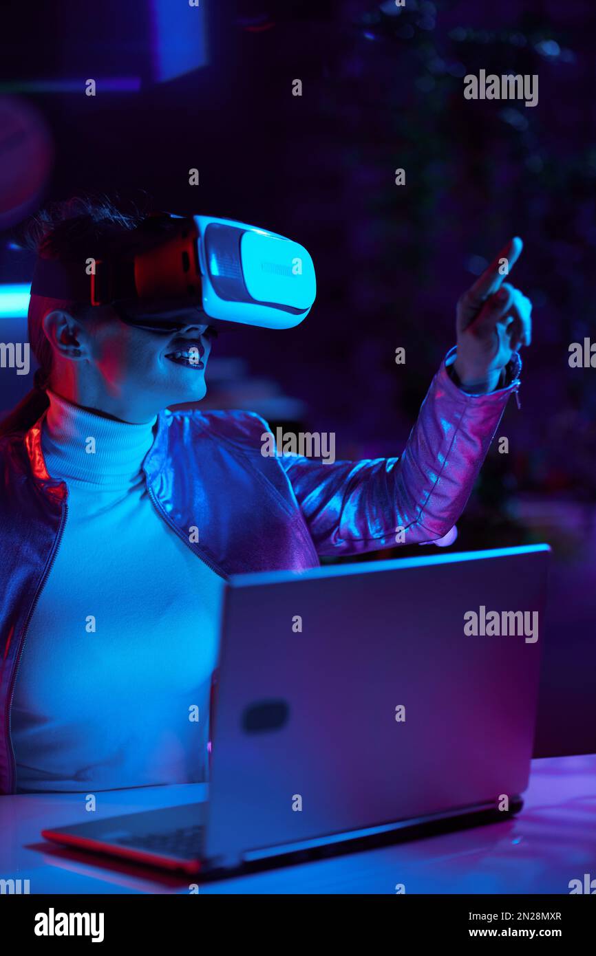 Neon metaverse futuristic concept. happy trendy 40 years old woman in ...