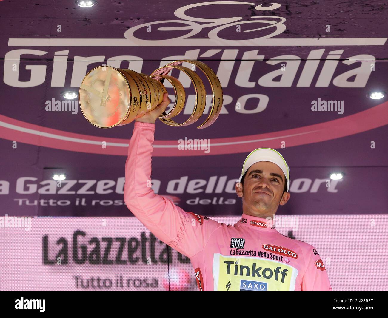 Spain's Alberto Contador holds up the trophy on the podium after ...