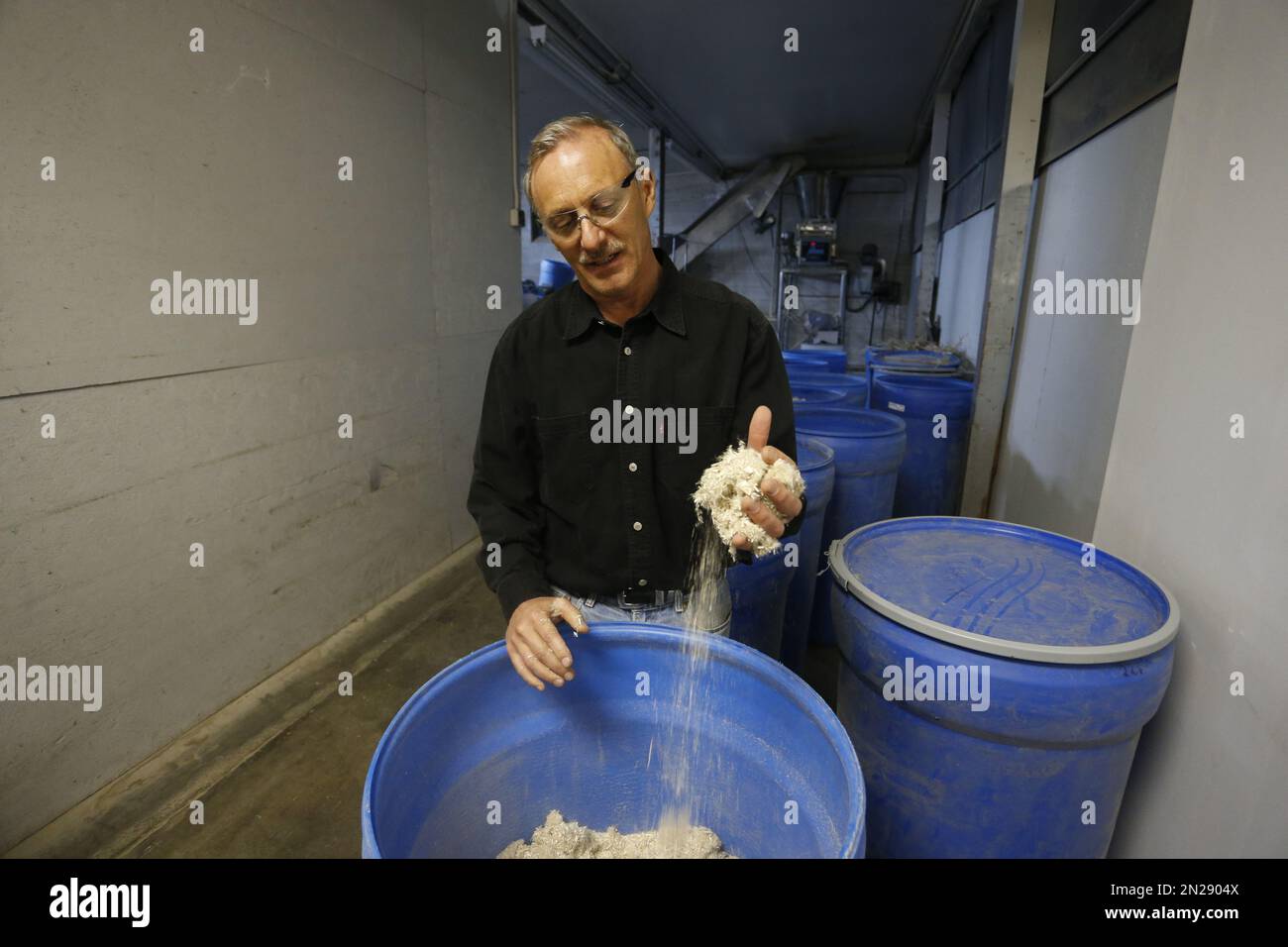 In this May 19, 2015 photo, biomass company CEO Ed Lehburger examines a ...