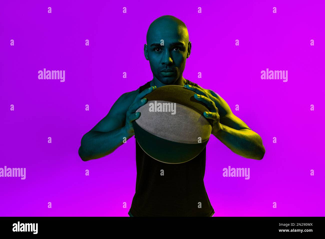 Portrait of a basketball player with ball on studio background ...