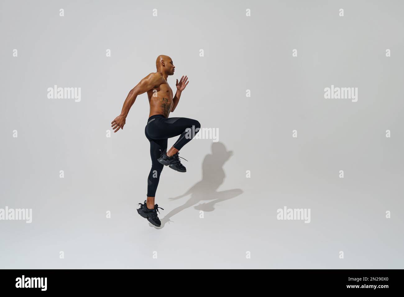 Professional male athlete running isolated on white studio background ...