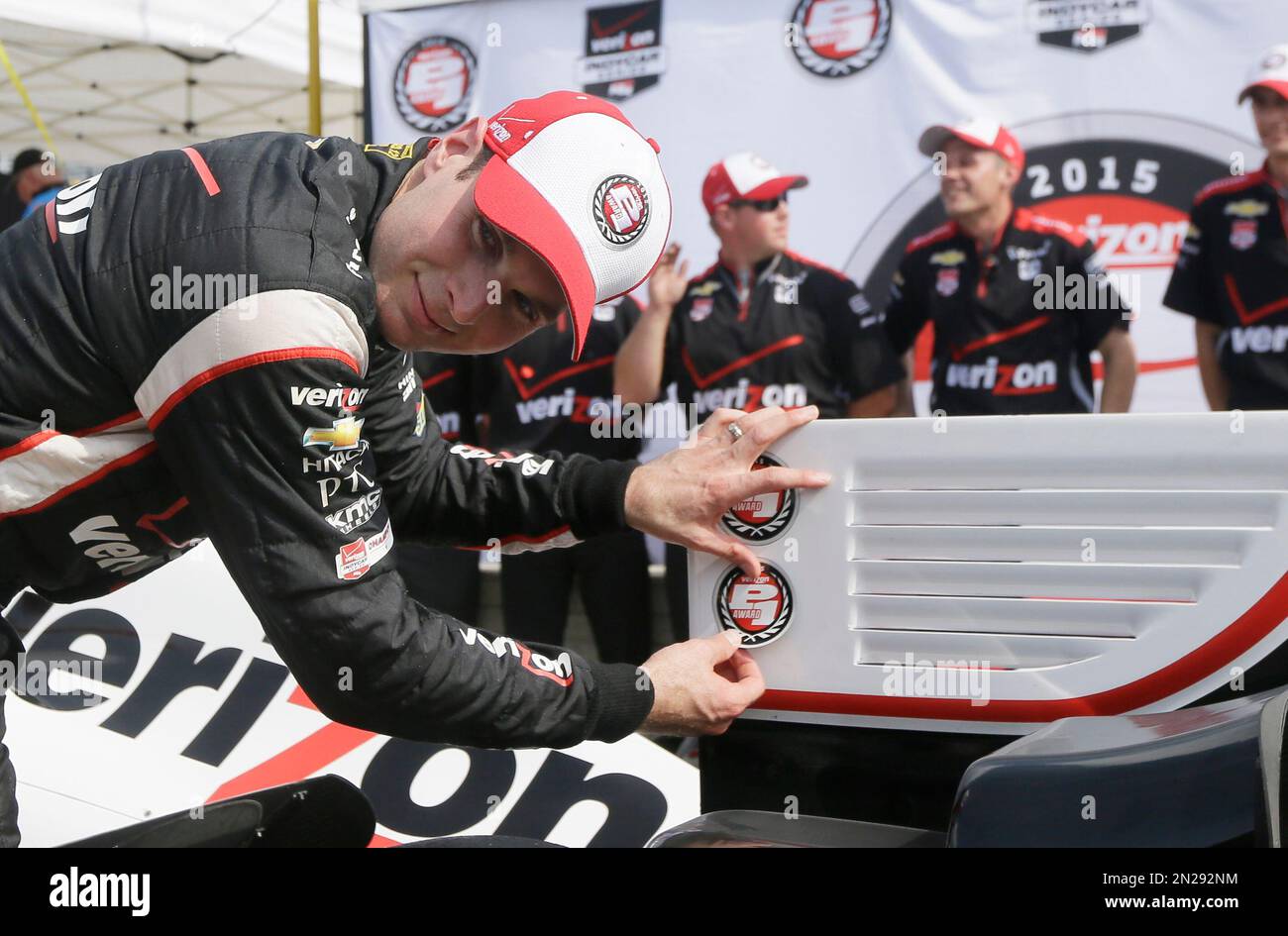 Will Power applies the pole position sticker to his rear spoiler after ...