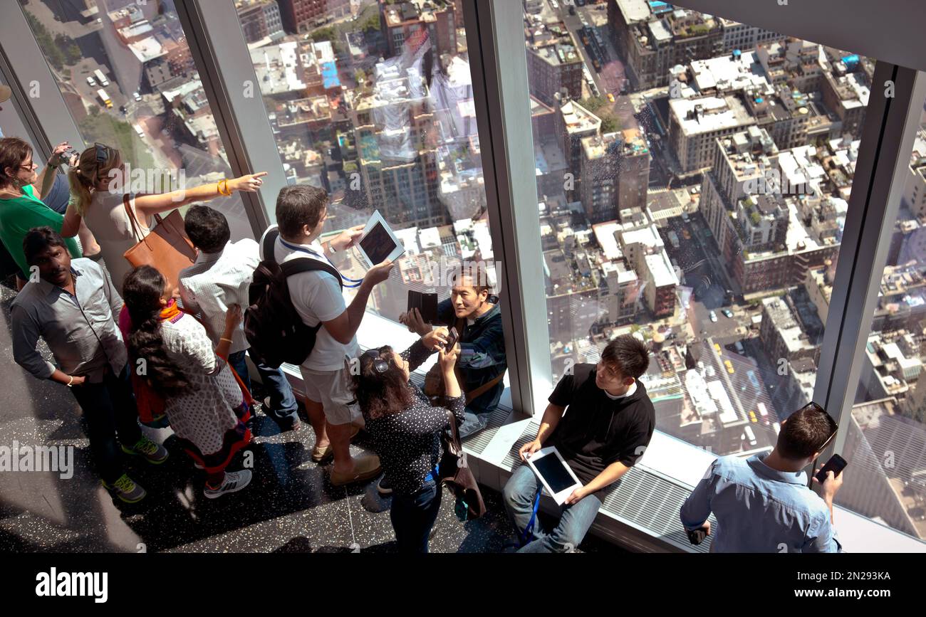 Some of the first visitors to the One World Observatory view the city ...